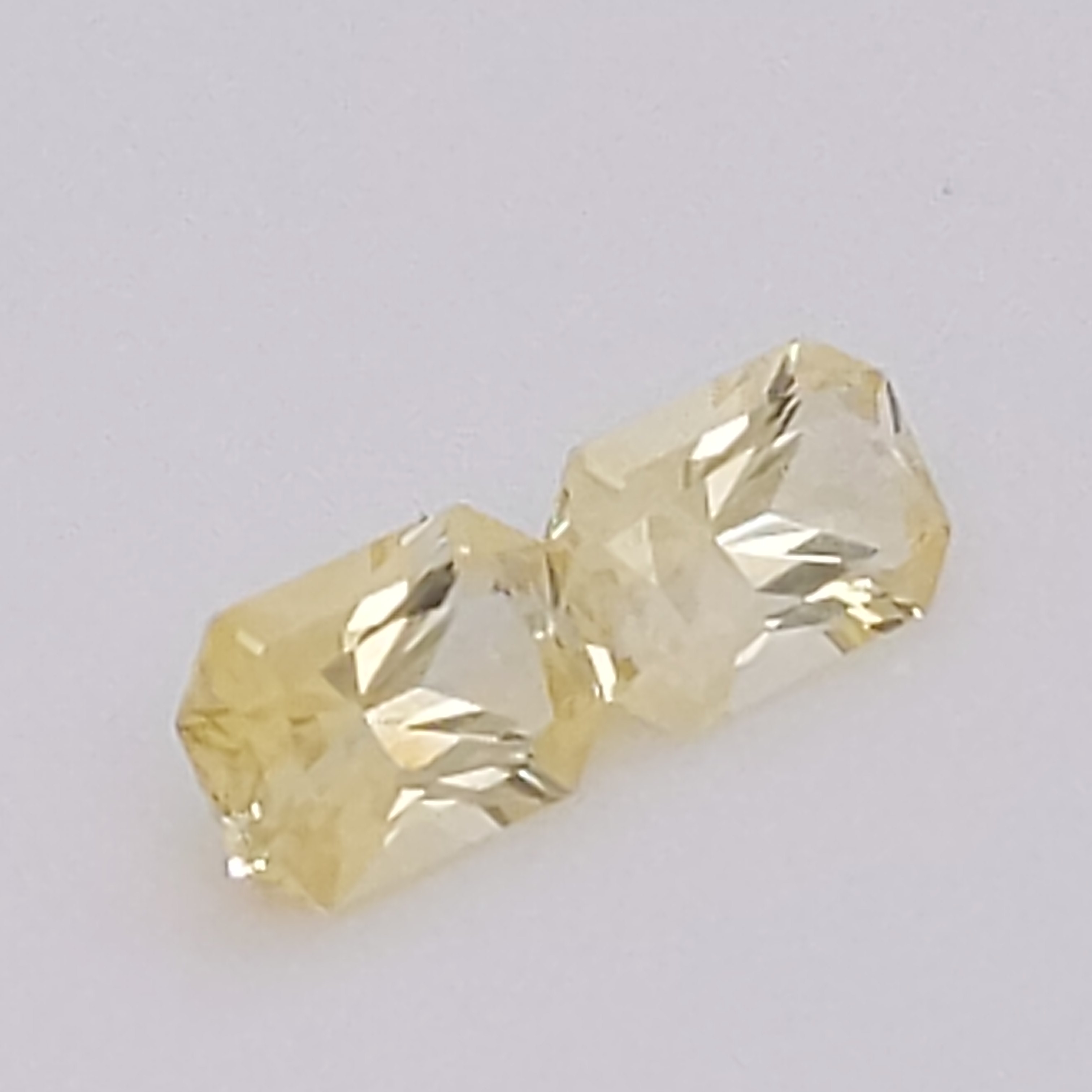 Ceylon emerald cut yellow sapphire pair